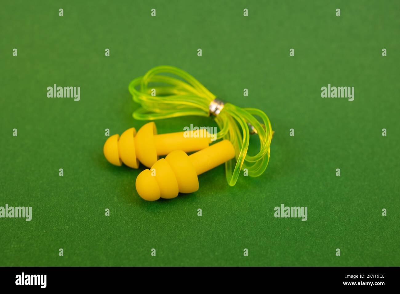 Silicone reusable ear plugs for human ears on green background Stock ...