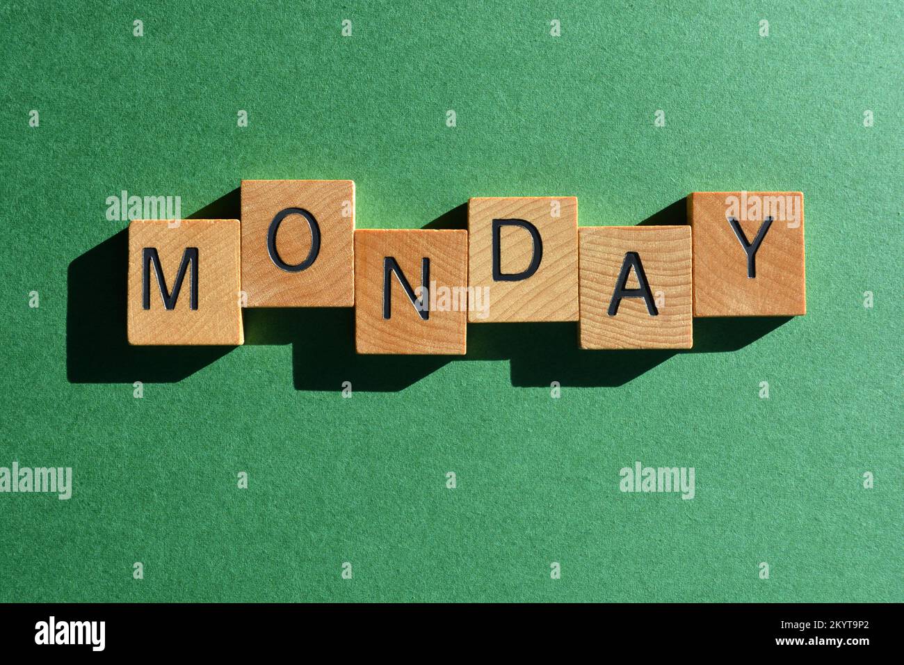Monday, word in wooden alphabet letters isolated on green background ...