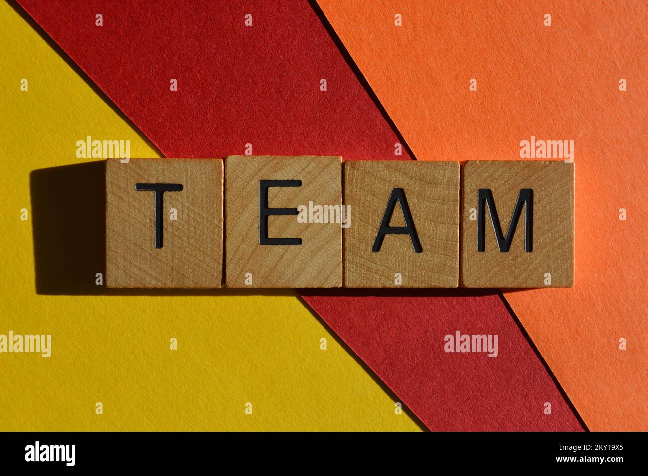 Team, word in wooden alphabet letters isolated on colourful background ...