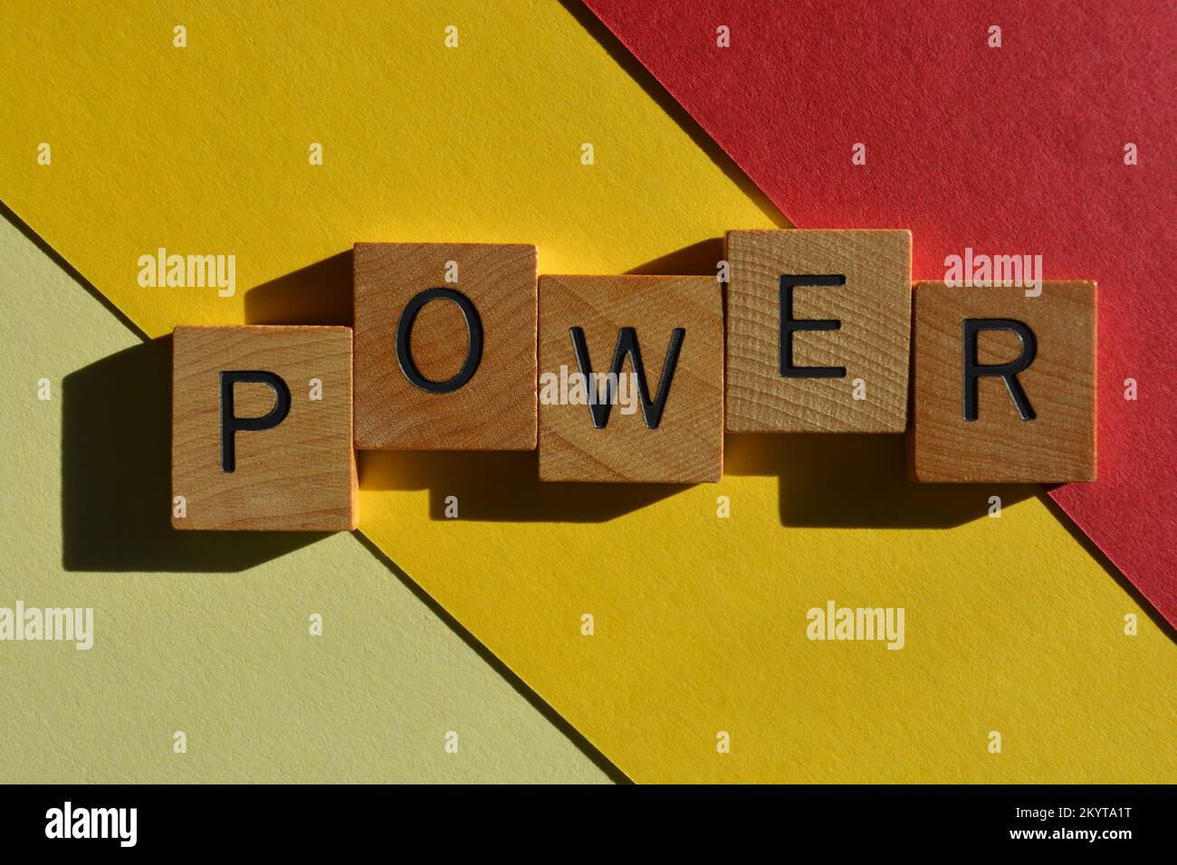 Power, word in wooden alphabet letters isolated on red, yellow and ...