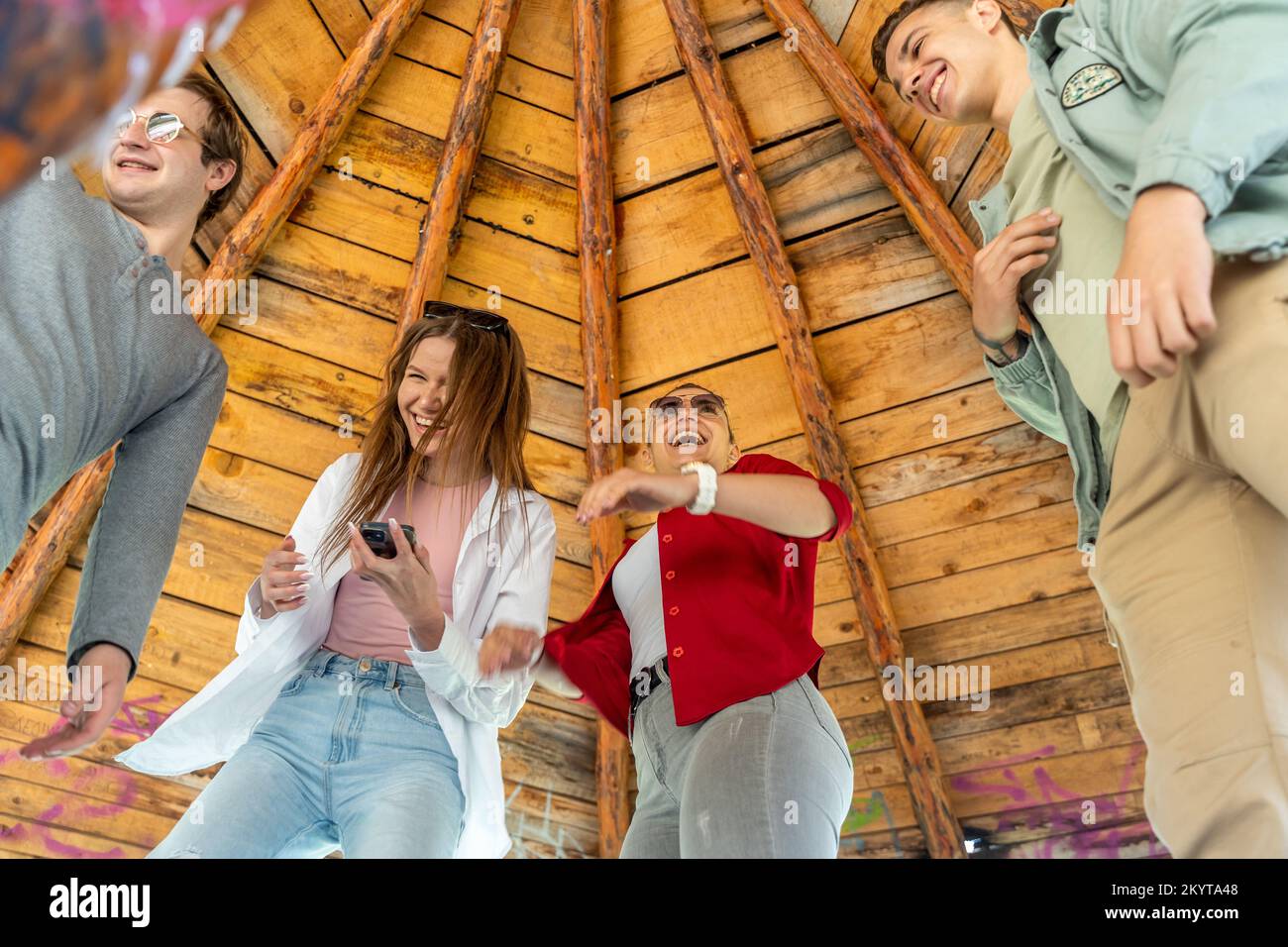 Young people enjoying spring summer time together at garden party ...