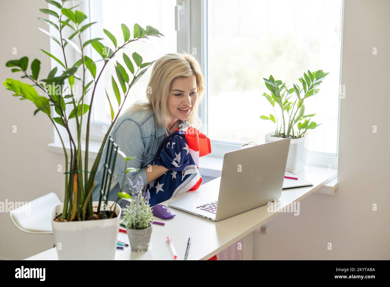 Happy woman employee sitting wrapped in USA flag, shouting for joy in ...