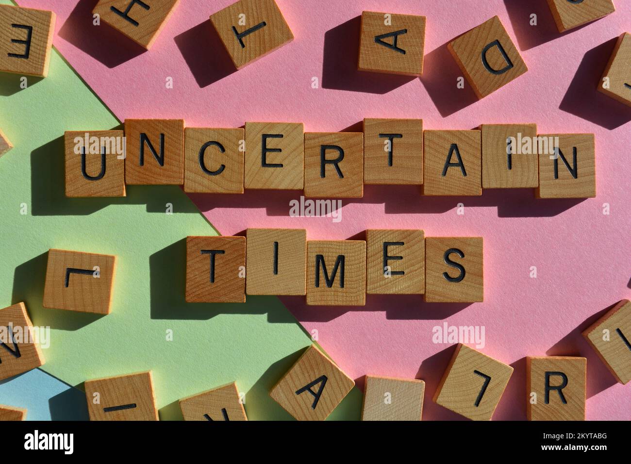 Uncertain Times, phrase surrounded by random wooden alphabet letters ...