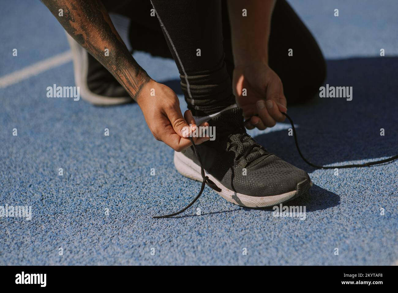 Woman lacing up sneakers hi-res stock photography and images - Alamy