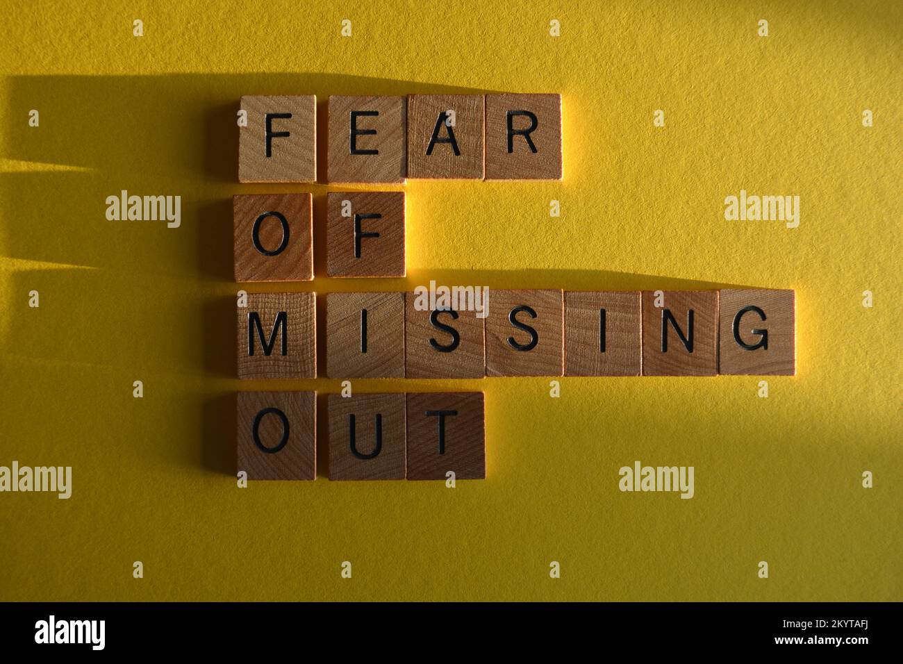 FOMO, internet slang or text speak for Fear Of Missing Out in wooden ...