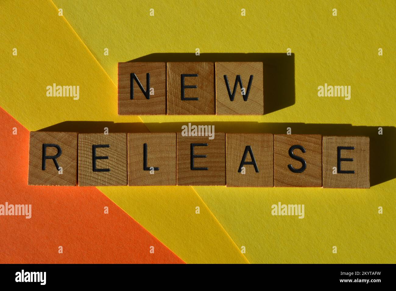 New Release, words in wooden alphabet letters isolated on yellow and ...