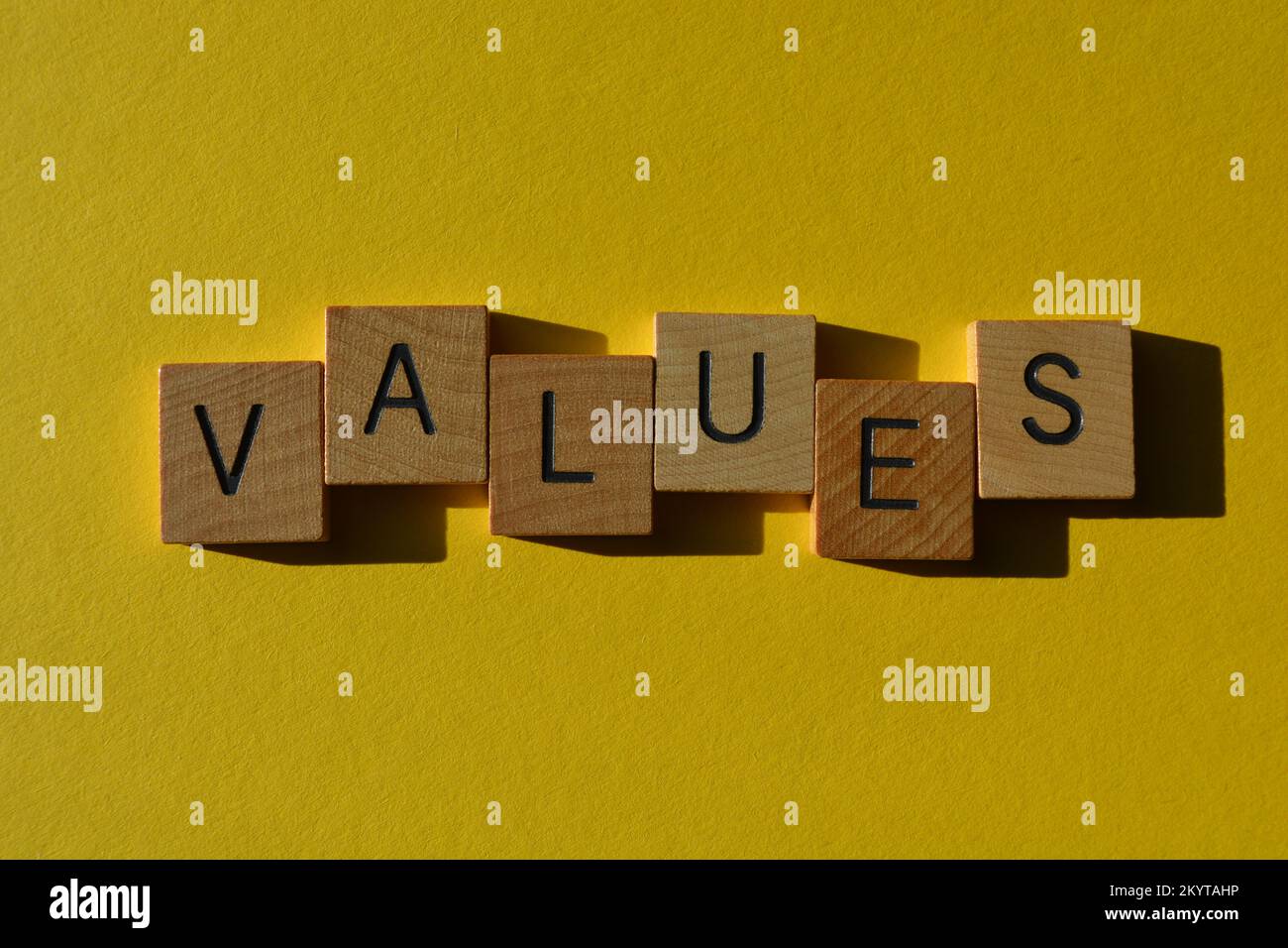 Values, word in wooden alphabet letters isolated on bright yellow ...