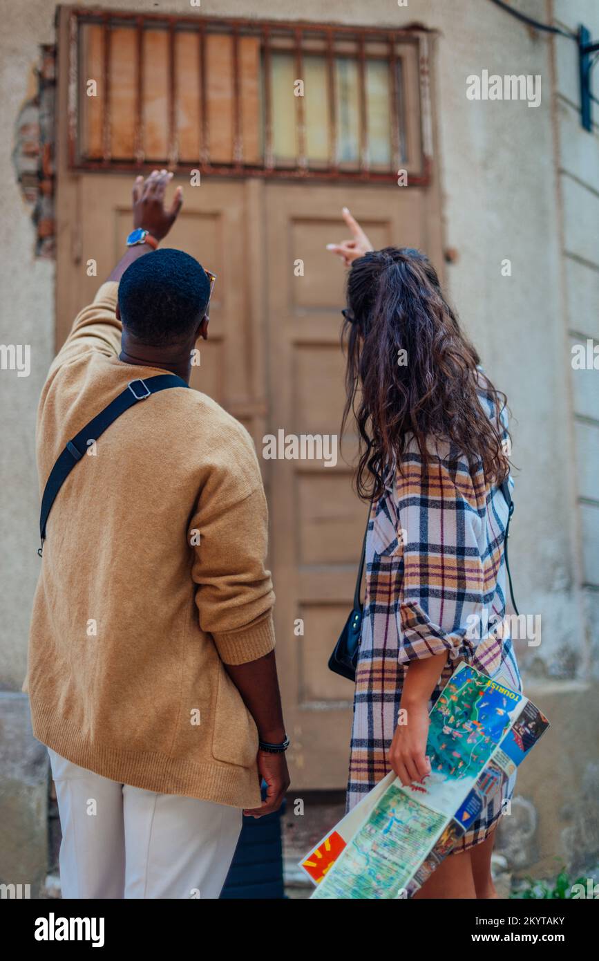 A woman is trying to explain something to her boyfriend. They are ...