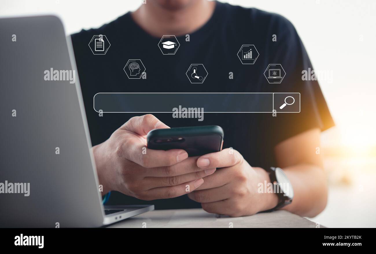 Online education man using mobil smart phone and laptop computer search ...