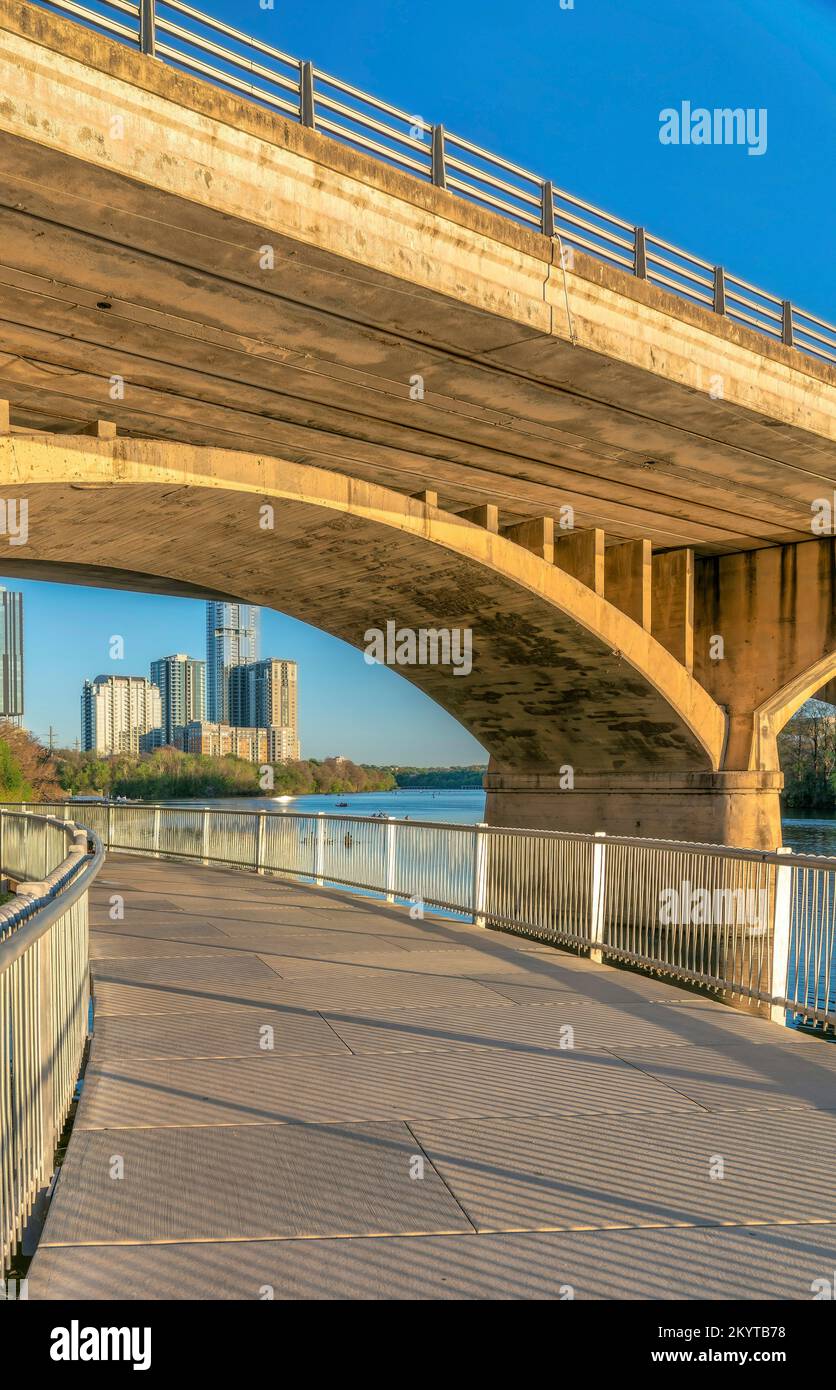 Bike path under a huge bridge over the scenic Colorado River in Austin ...
