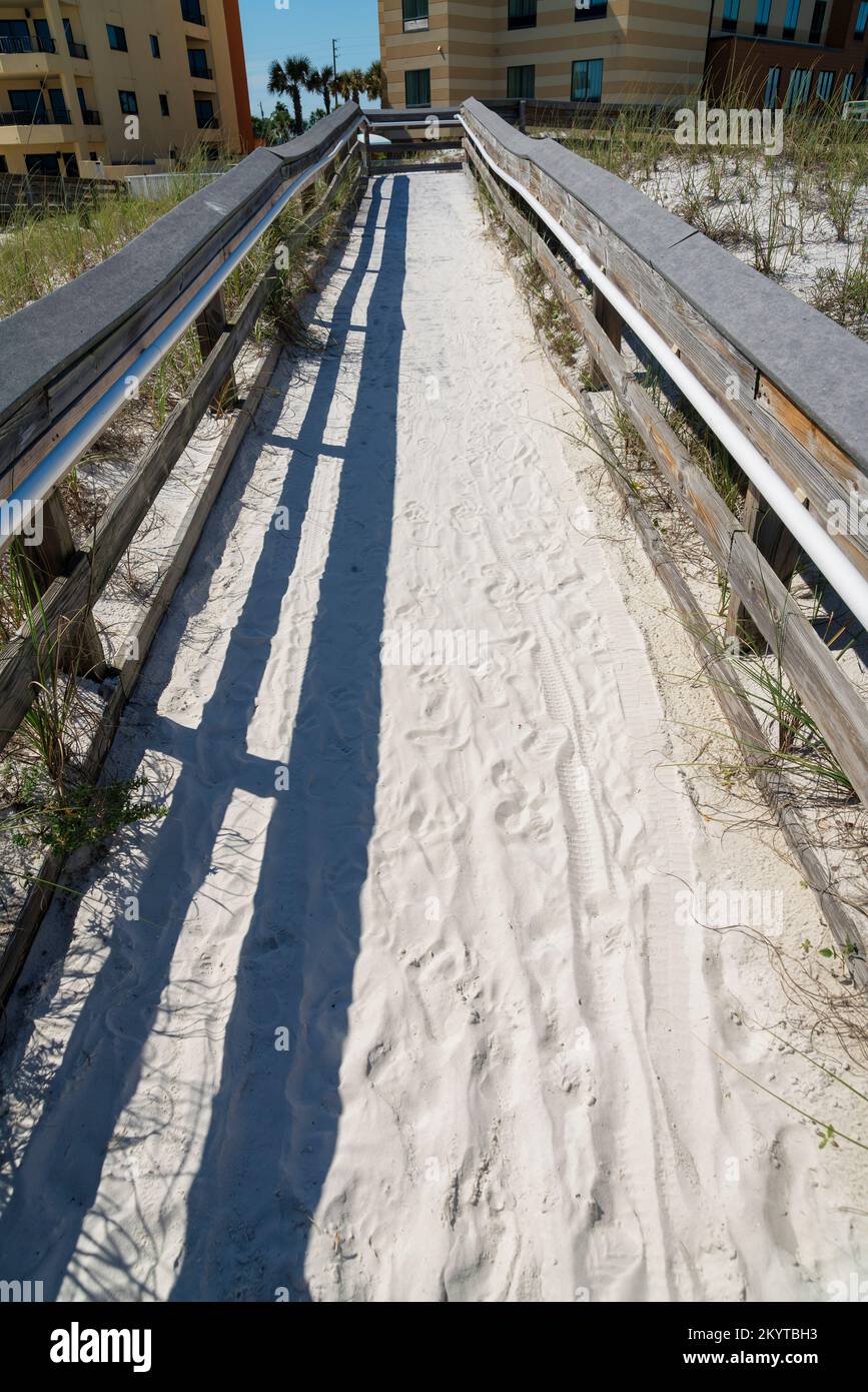 A narrow walkway of fine white sand that leads to the beach in Destin ...