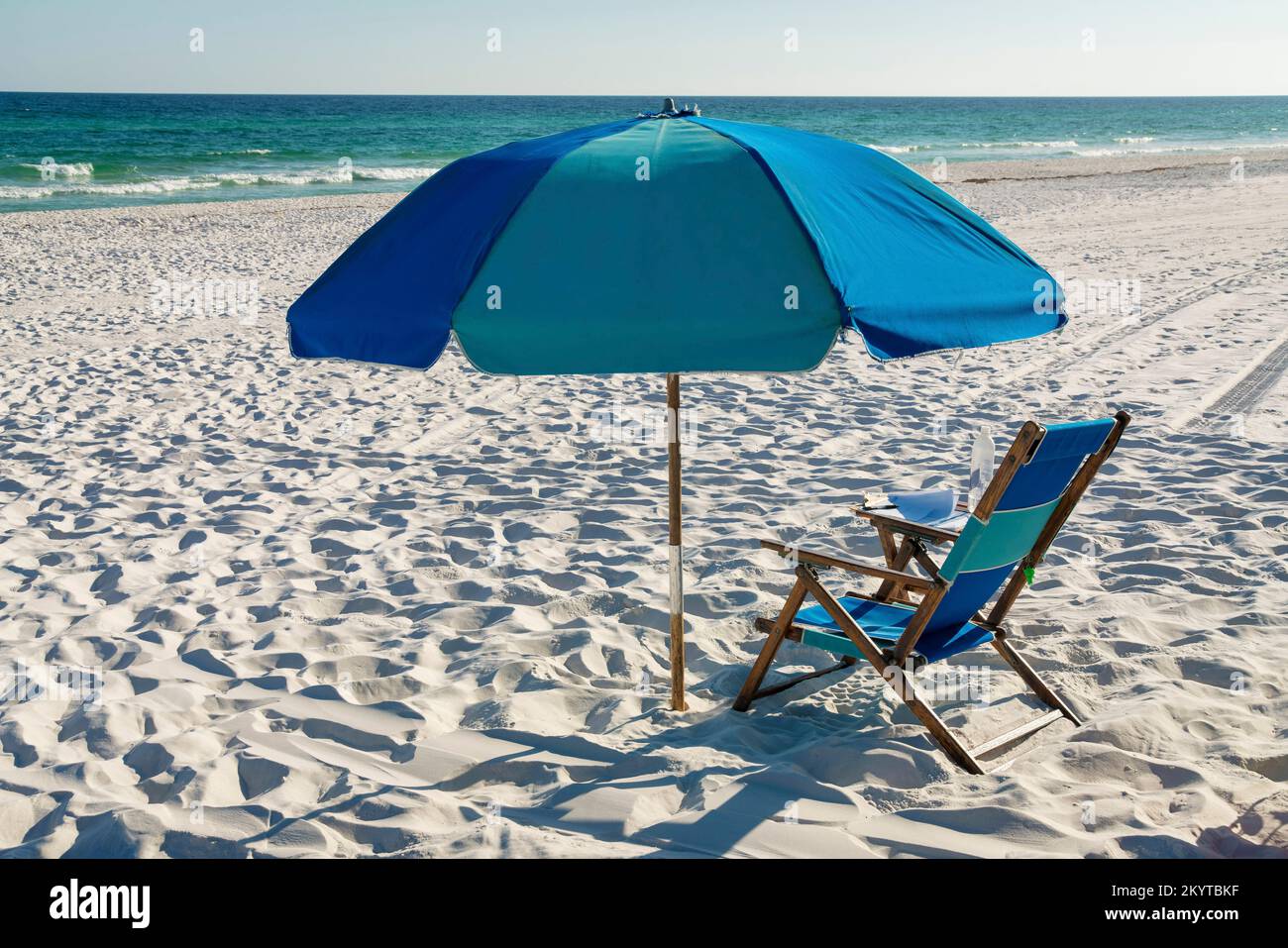 Beach folding chair under a blue umbrella with view of ocean in Destin ...