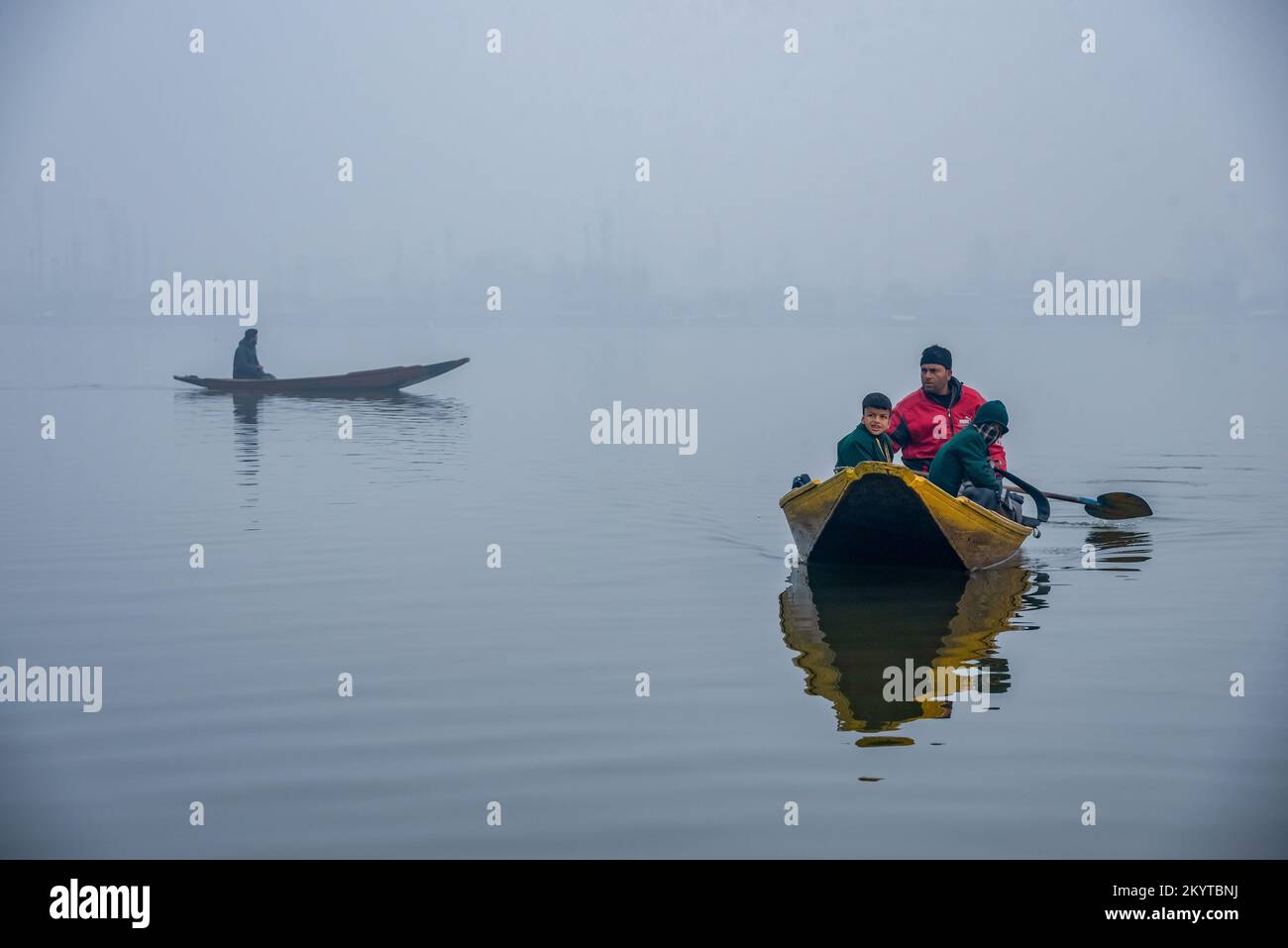 Srinagar, India. 02nd Dec, 2022. A man ferries school kids on Dal lake ...