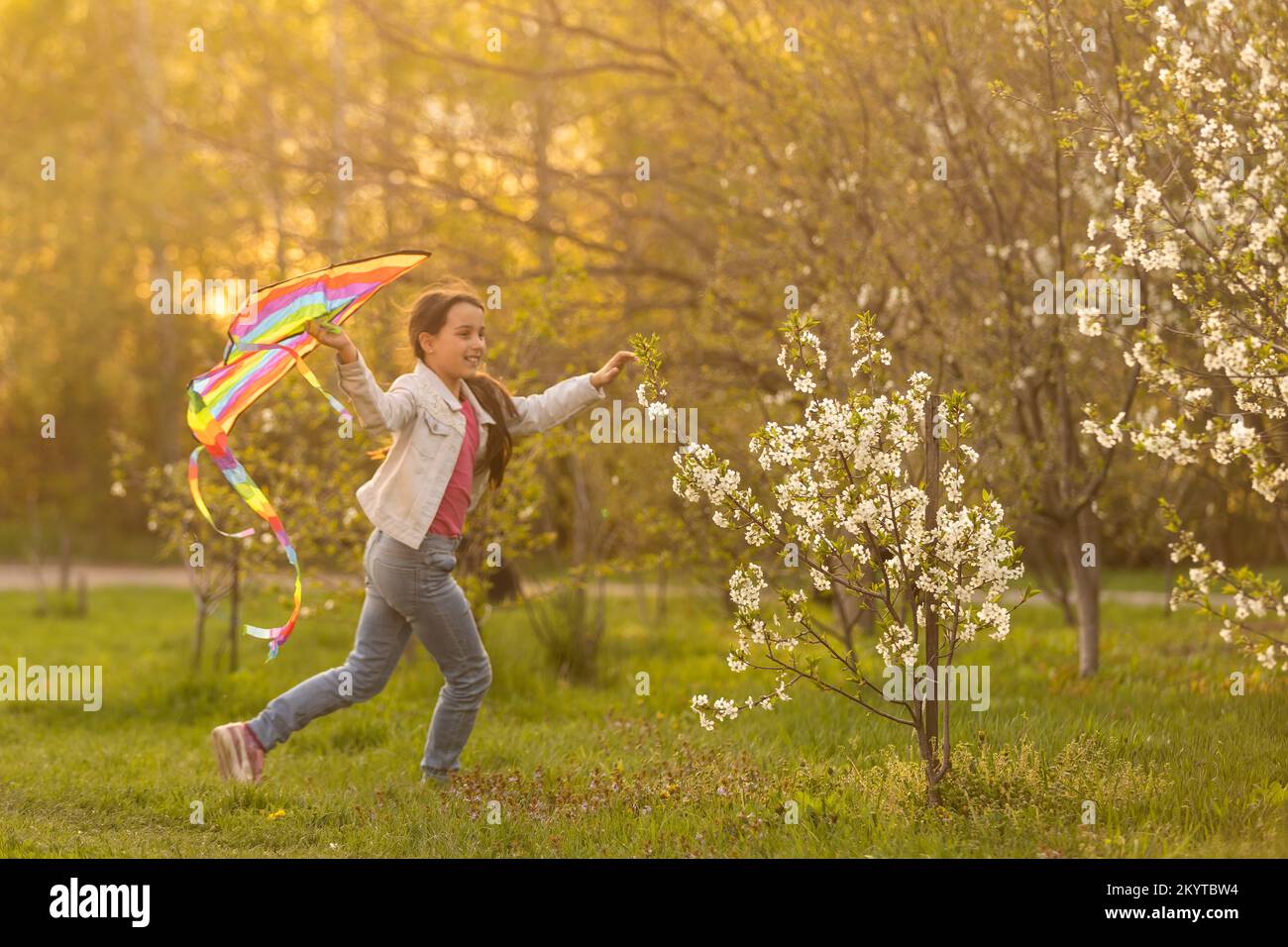 little girl with a kite in the spring Stock Photo - Alamy