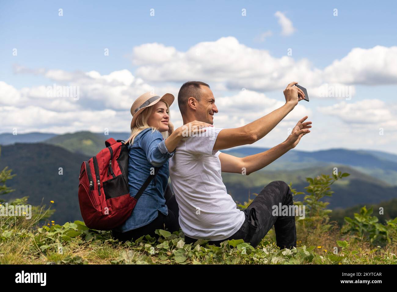 Portrait of beautiful young couple enjoying nature at mountain peak Stock Photo - Alamy