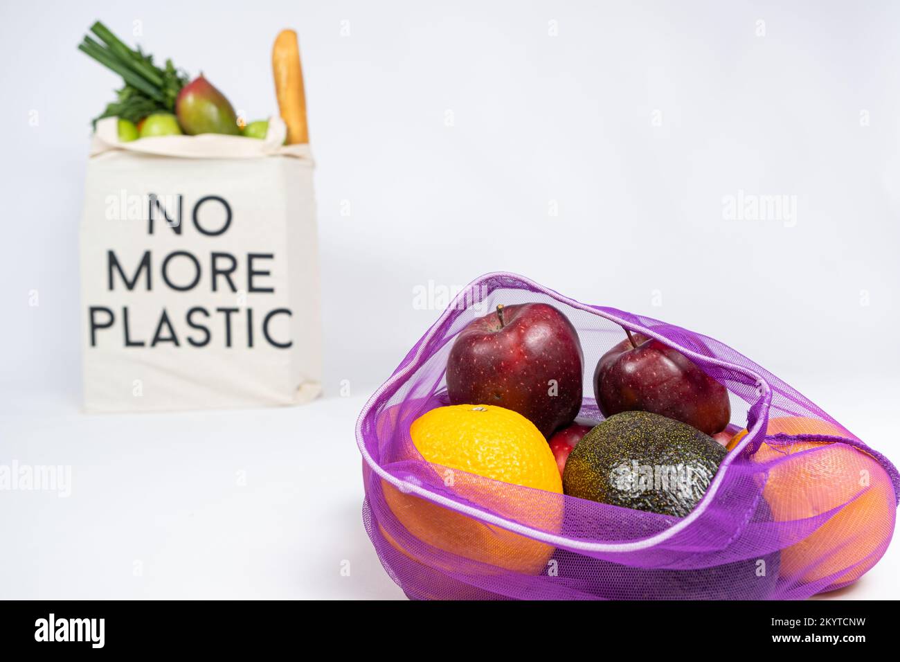 Fruit net and fabric bag with text no more plastic. Rejection of ...