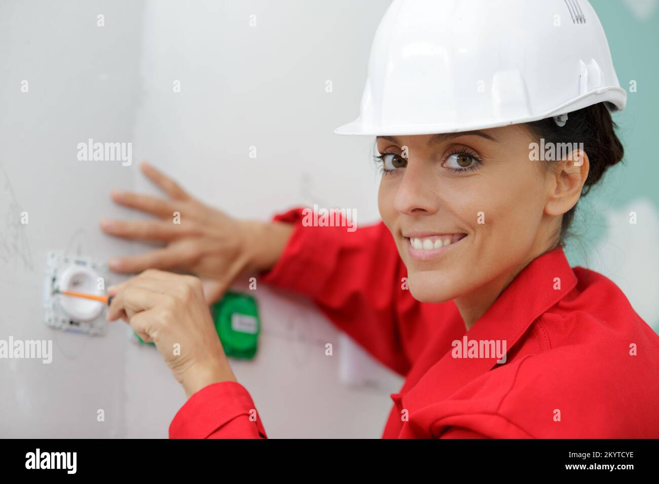 female electrician testing a wall socket Stock Photo - Alamy