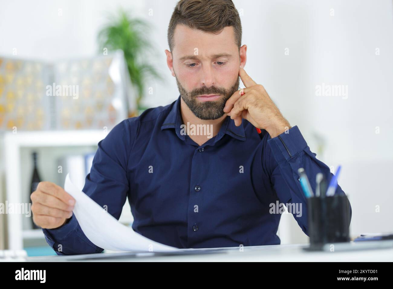 an architect looking at notes Stock Photo - Alamy