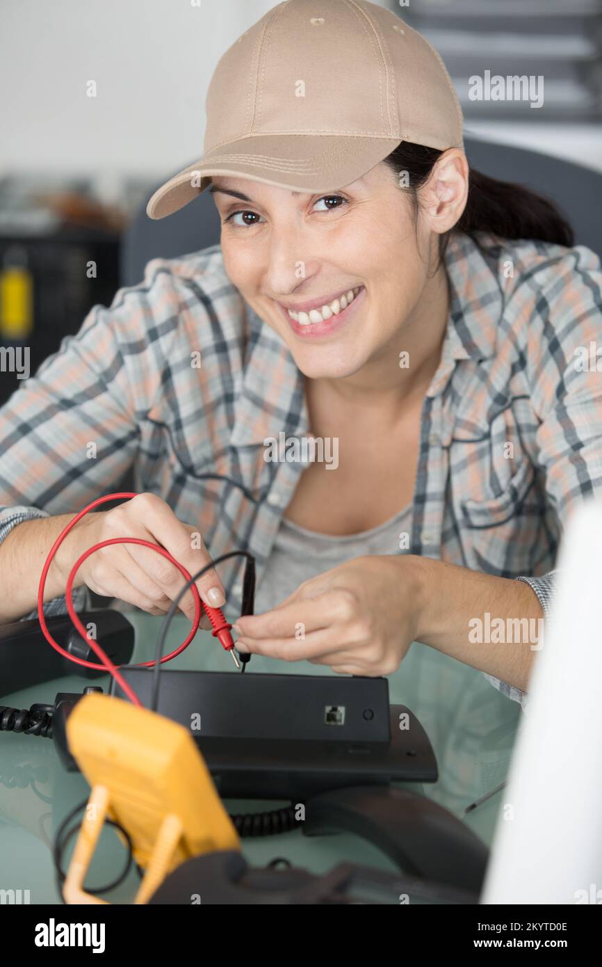 female electrician checking voltage with multimeter Stock Photo - Alamy