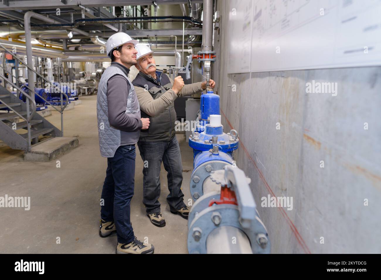 factory engineers operating hydraulic tube bender Stock Photo - Alamy