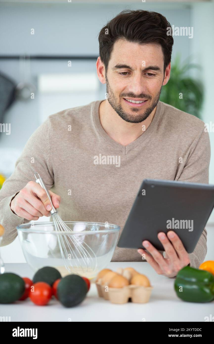 cooking, technology, advertising and home concept - close up of male ...