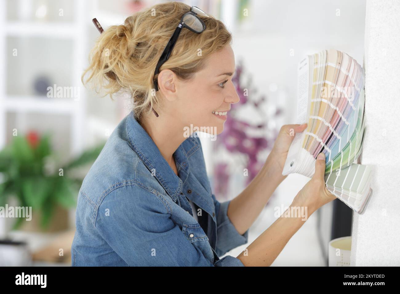 portrait of pretty blonde woman looking at color swatches Stock Photo ...