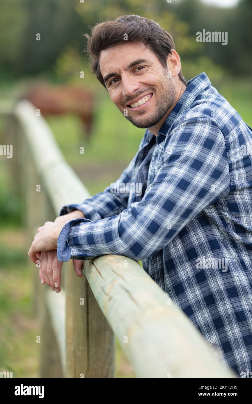 handsome middle aged man leaning at fence Stock Photo - Alamy