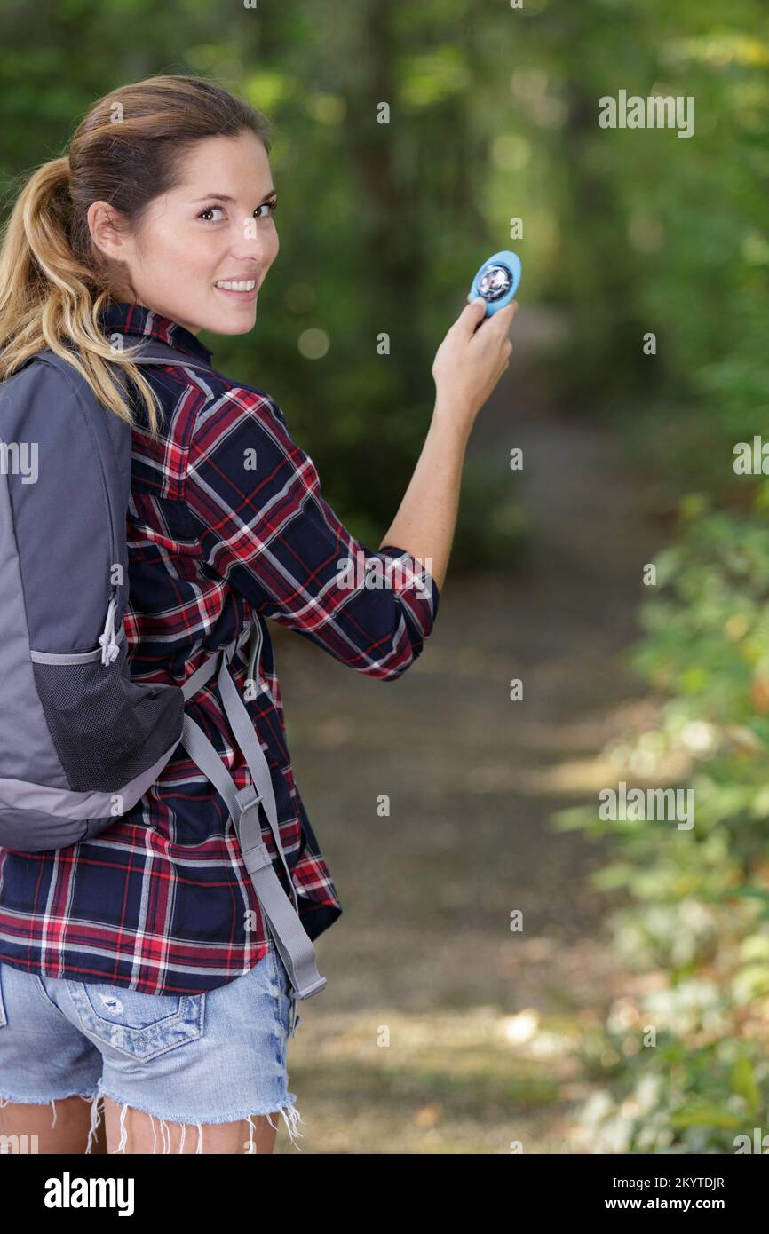 woman using a compass in the forest Stock Photo - Alamy