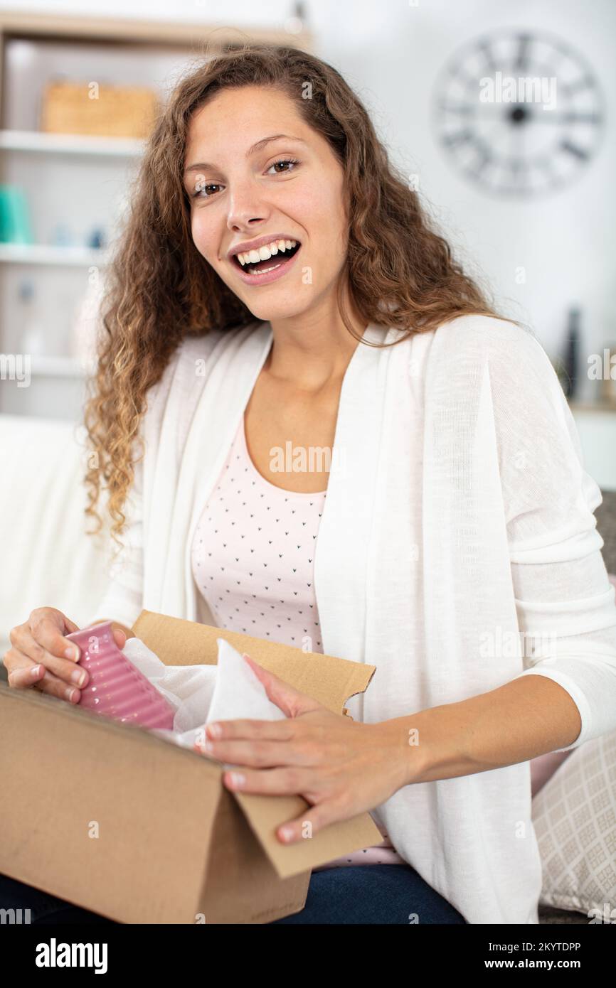 excited woman at home she has received a postal parcel Stock Photo - Alamy