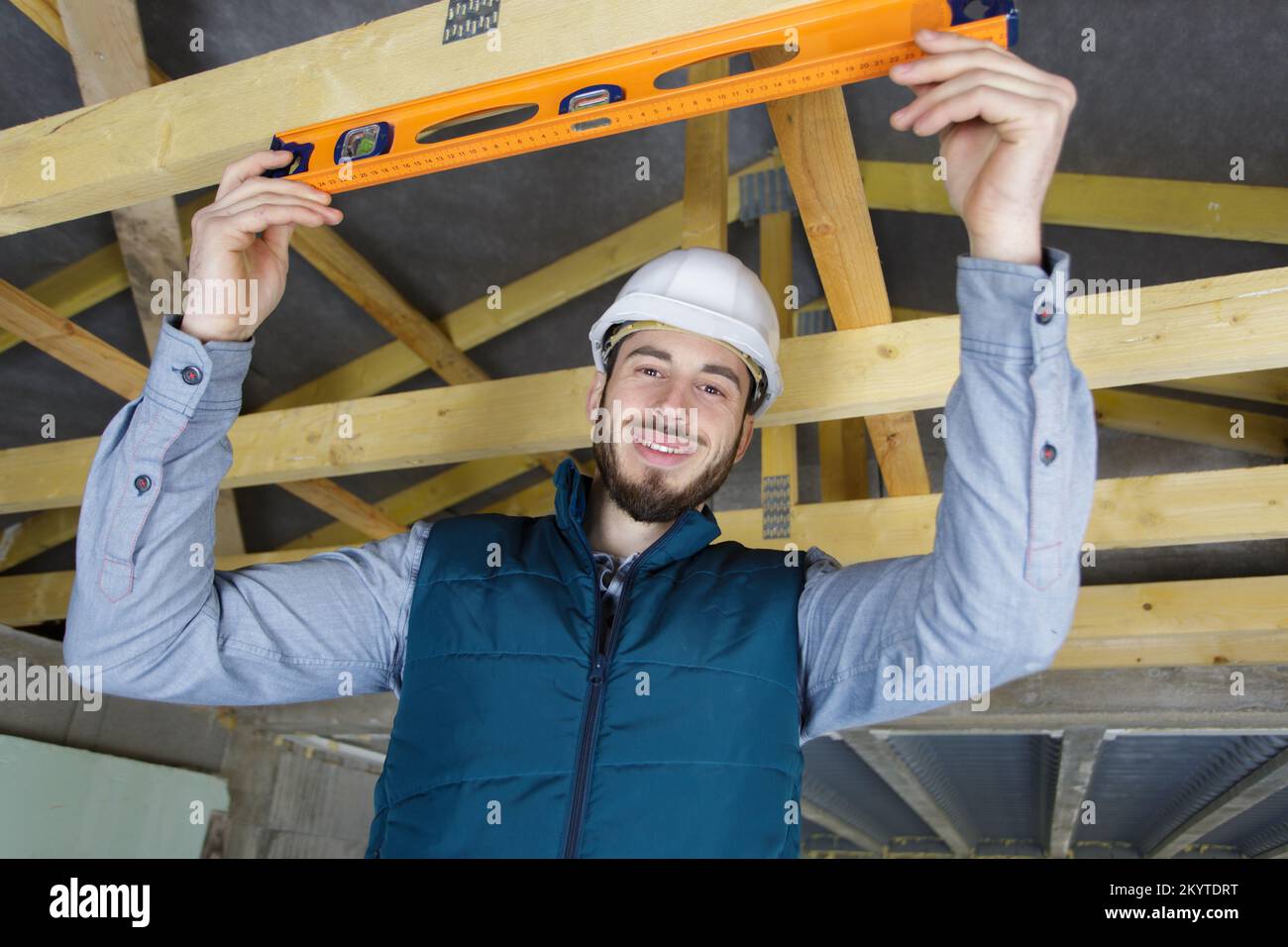 house renovation worker checking the alignment of a ceiling Stock Photo ...