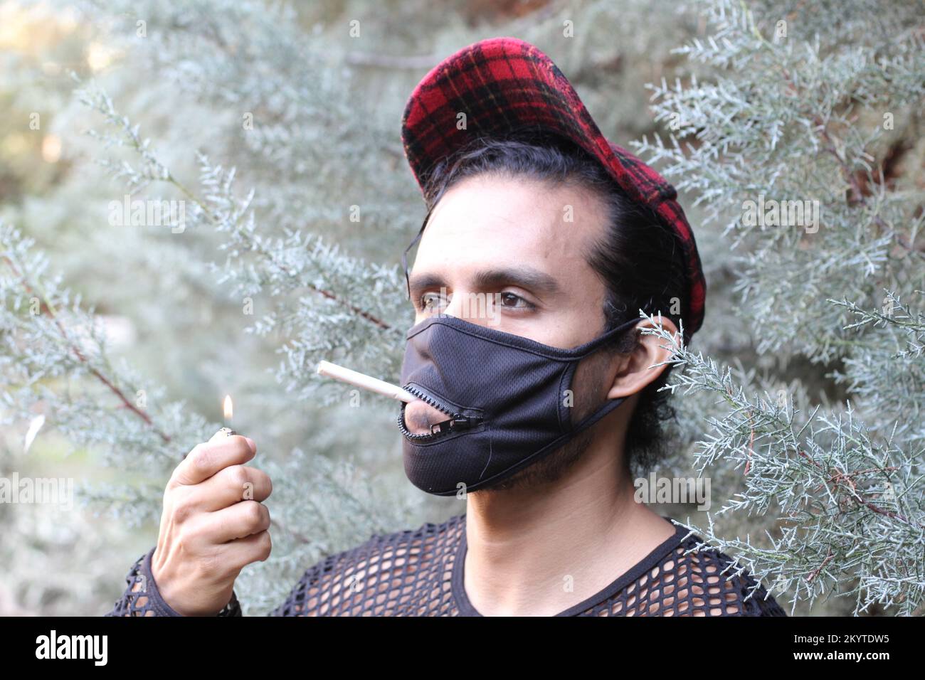 Fashionable guy smoking cigarette during a pandemic Stock Photo - Alamy