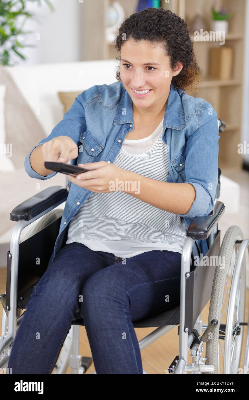 handicapped woman pressing the remote Stock Photo - Alamy