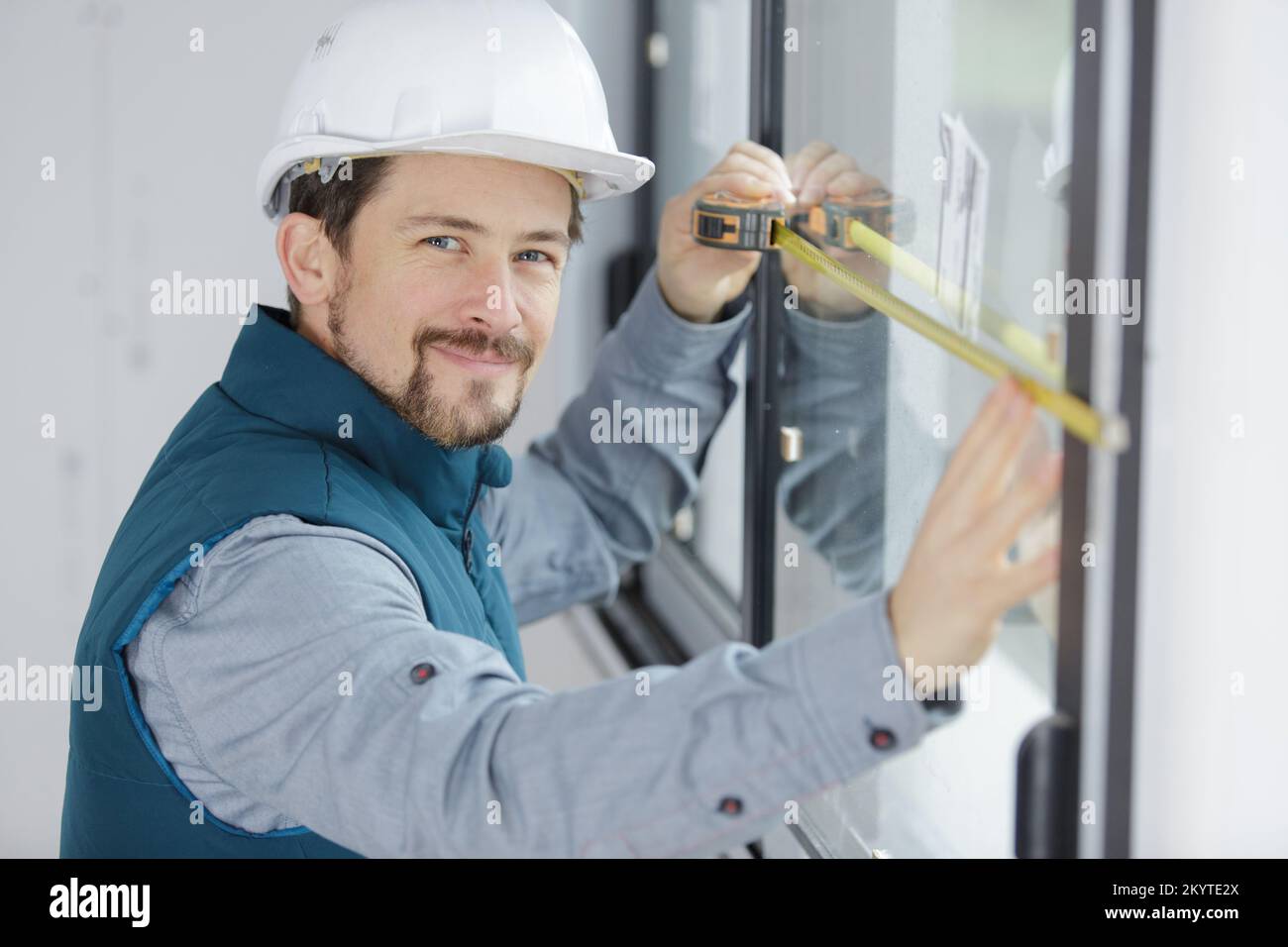 man measuring window prior to installation of roller shutter Stock ...