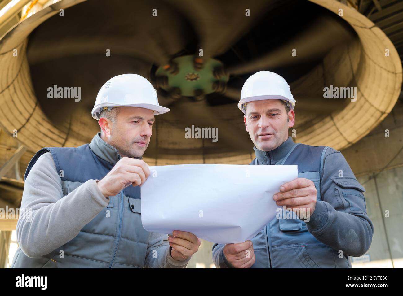 engineer and foreman pointing to drawing paper Stock Photo - Alamy