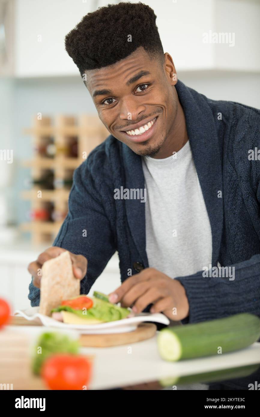 man at home making a sandwich Stock Photo - Alamy