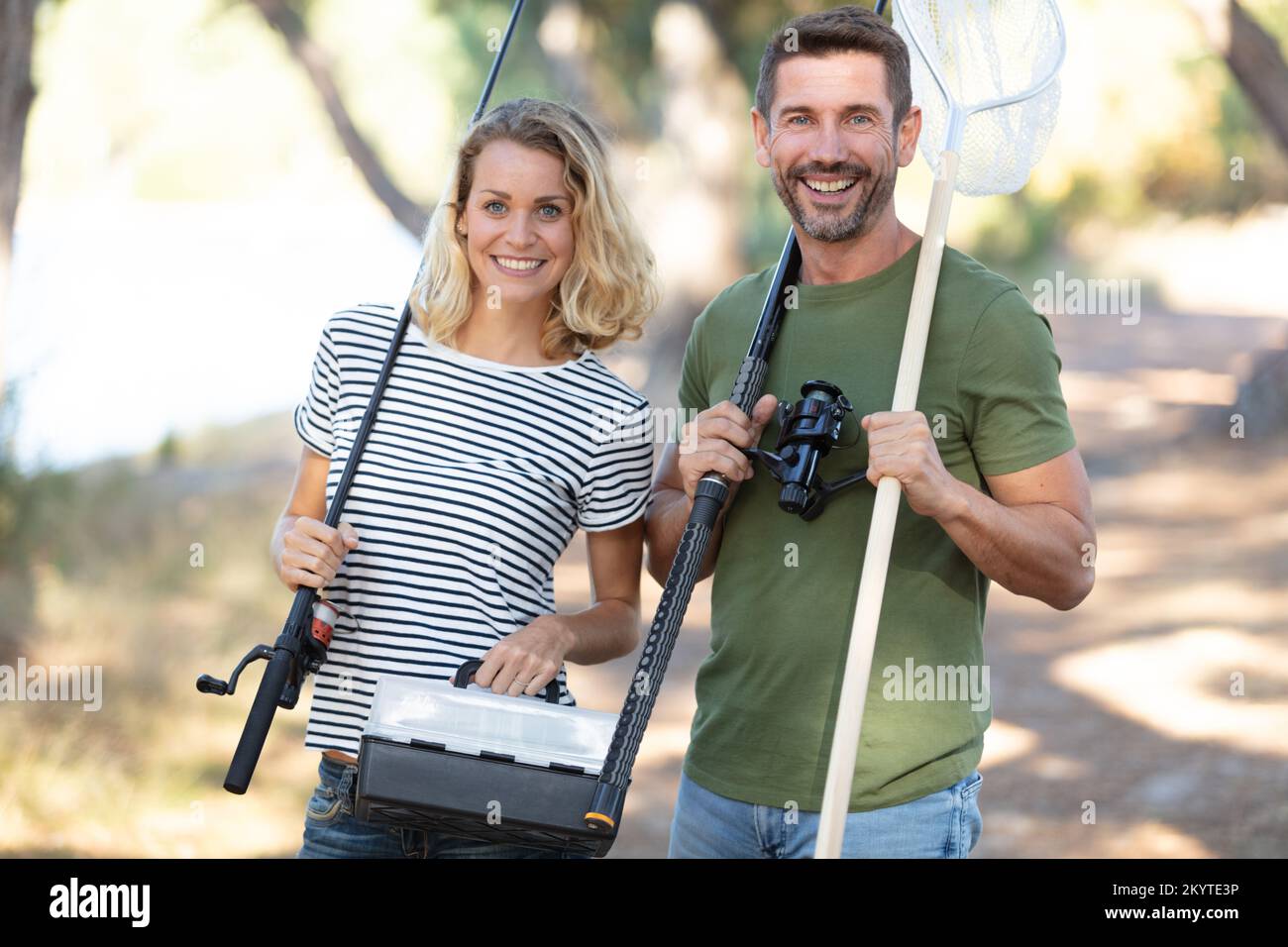 couple going fishing with fish rod and net Stock Photo - Alamy