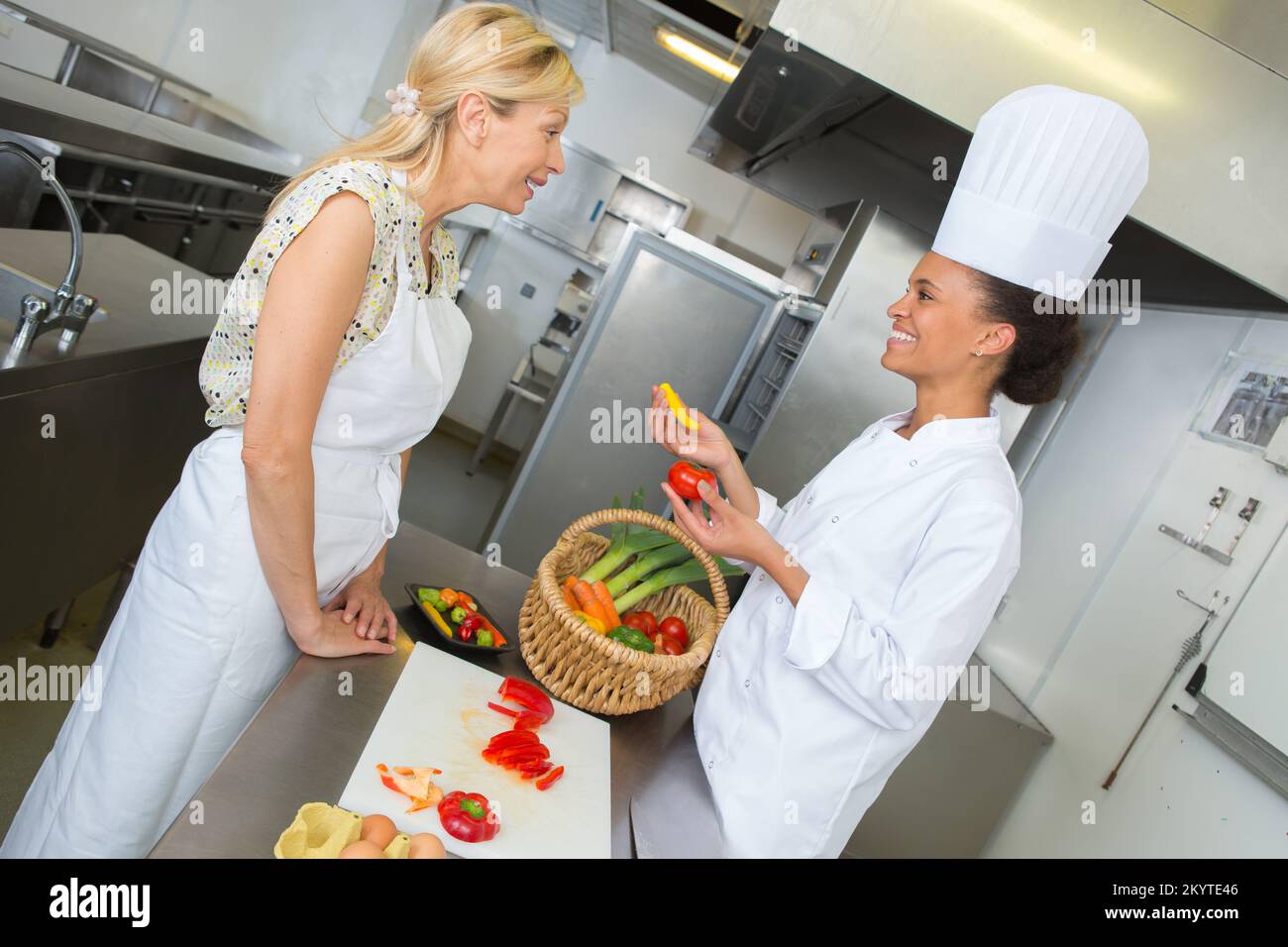 two female and male young cooks wearing uniform Stock Photo - Alamy