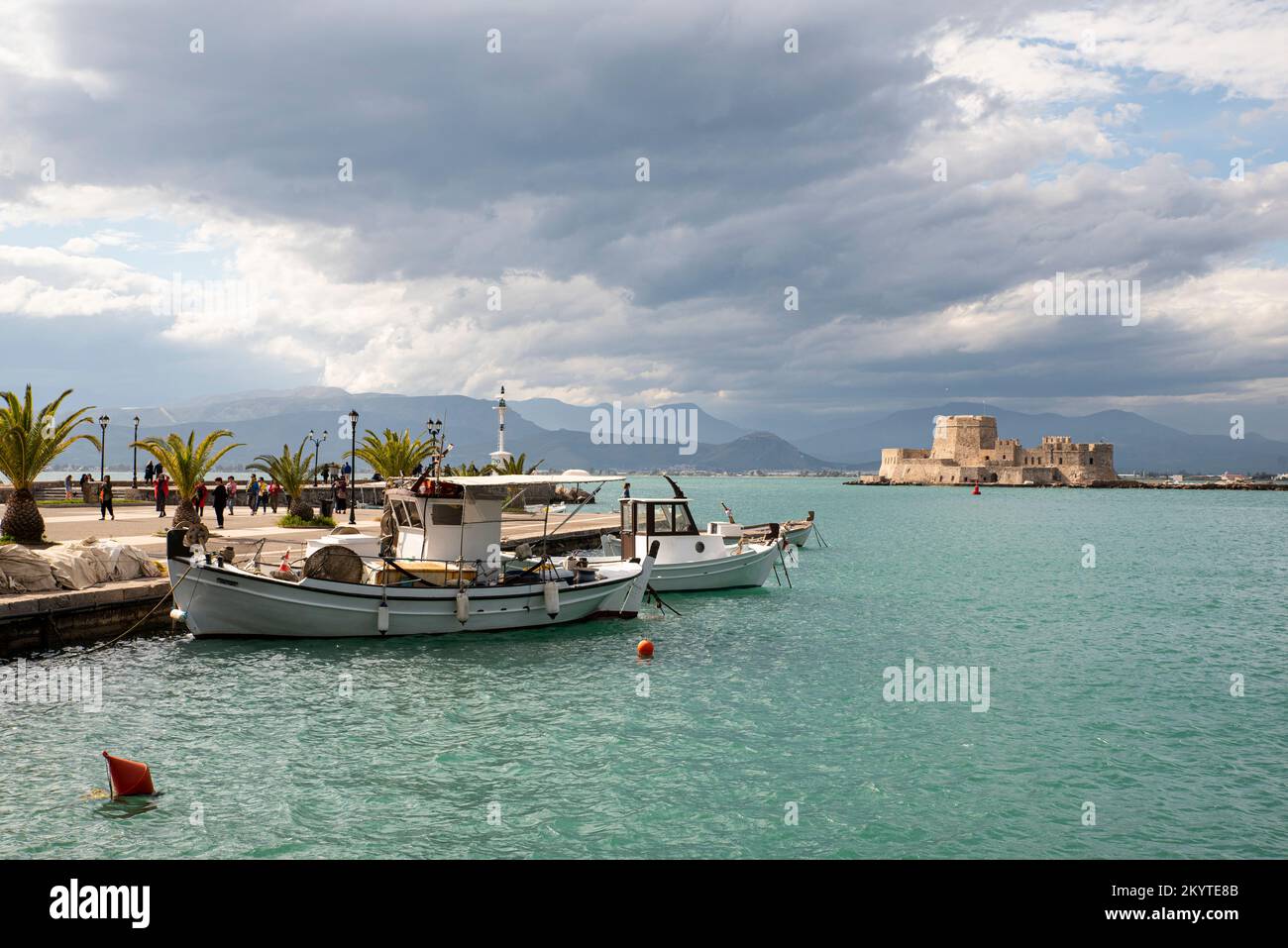Fishing boats at the port of Nafplio and the castle bourtzi on the ...