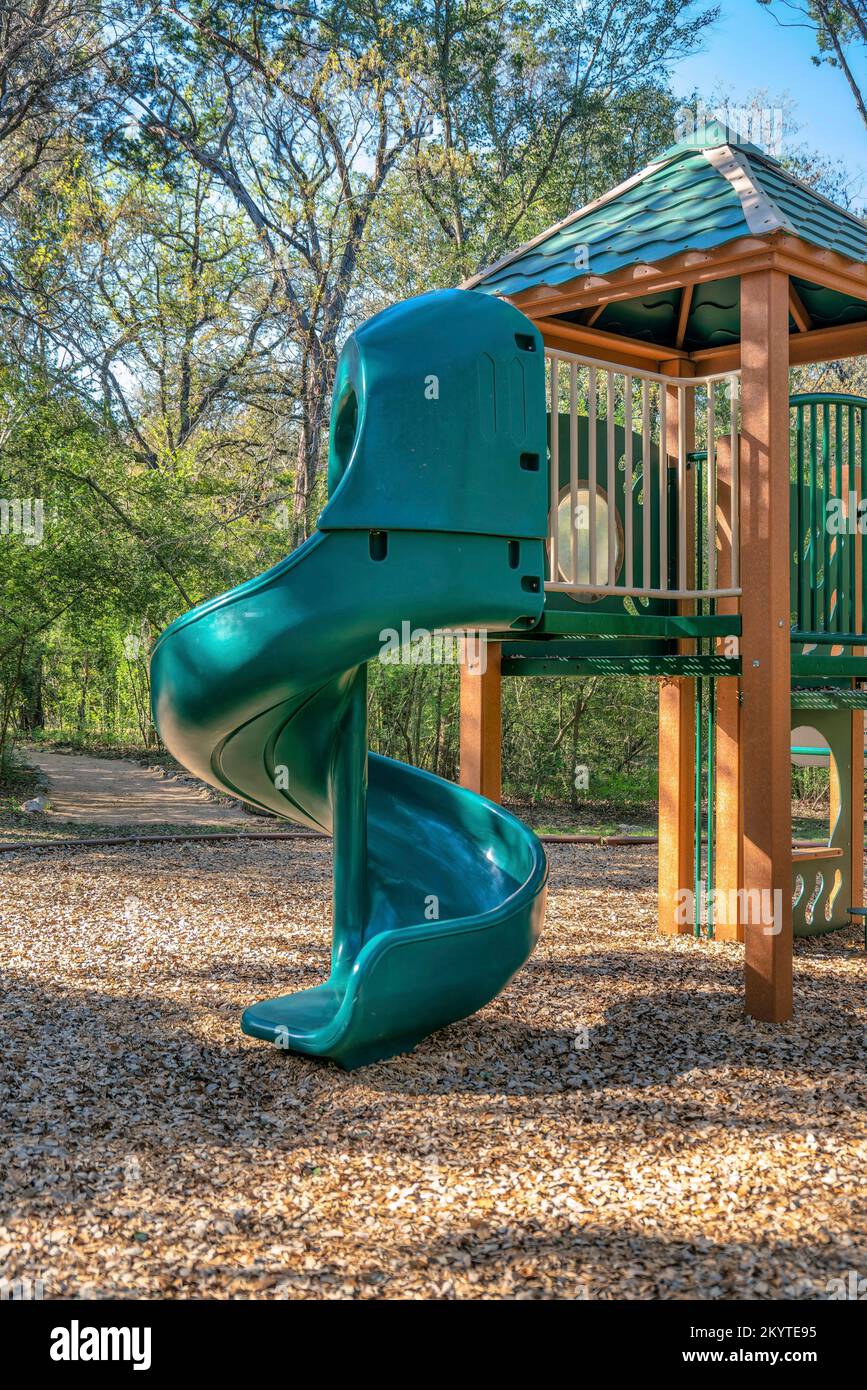 Austin, Texas- Spiral slides on a community playground. View of a slide ...