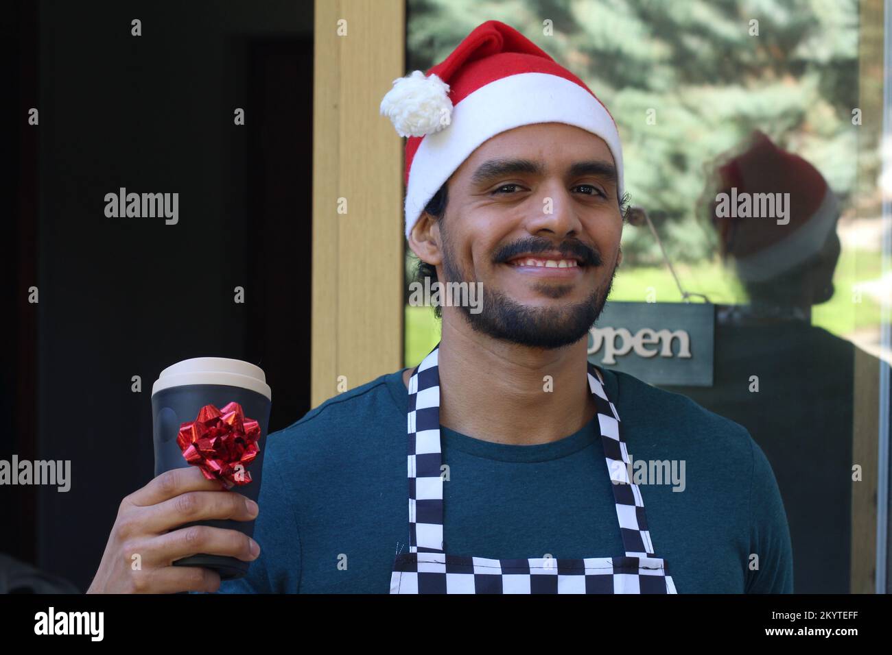 Joyous waiter doing a special promotion during christmas Stock Photo ...