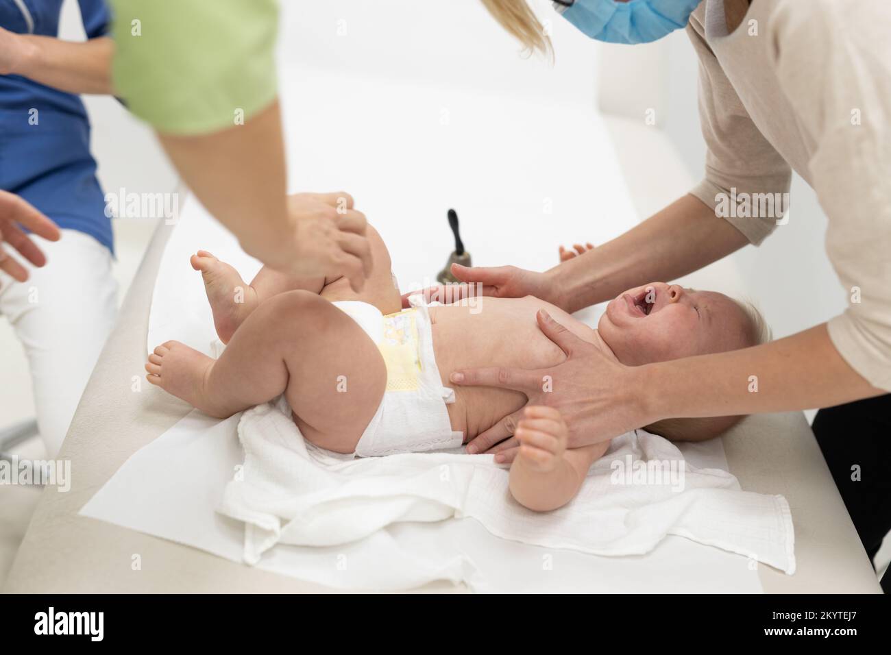 Baby beeing vaccinated by pediatrician in presence of his mother ...