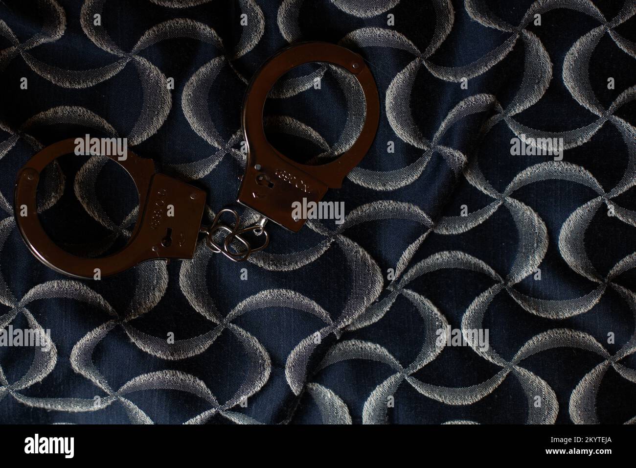 Classic chain handcuffs on black background Stock Photo - Alamy