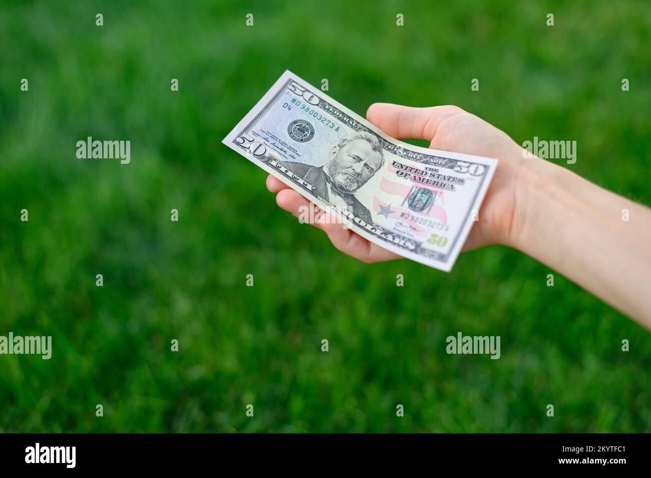 First person top view photo of hands holding fan of Dollar banknotes on ...