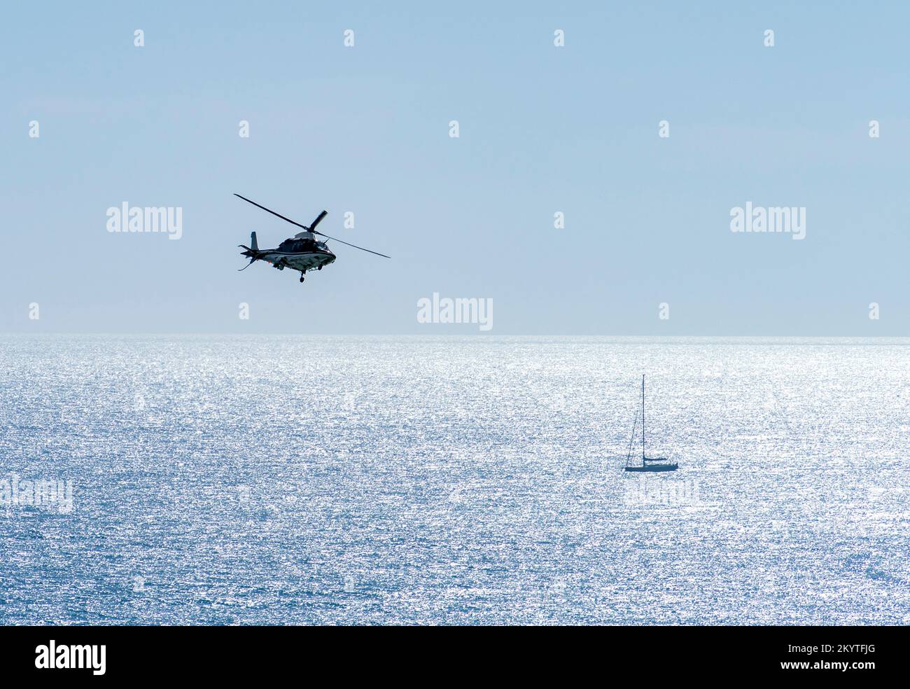 Helicopter flying over open sea seen in Italy Stock Photo - Alamy