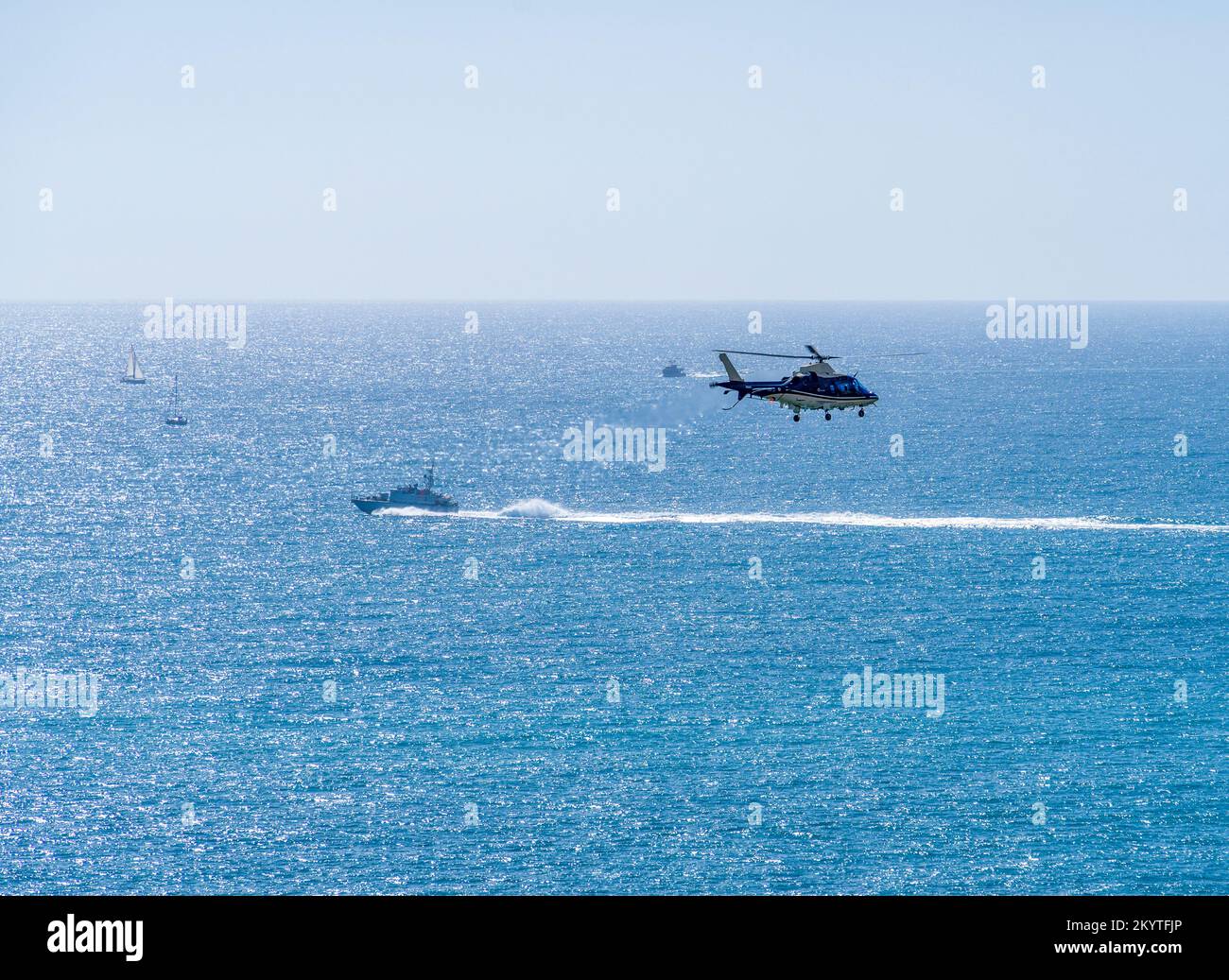 Helicopter flying over open sea seen in Italy Stock Photo - Alamy