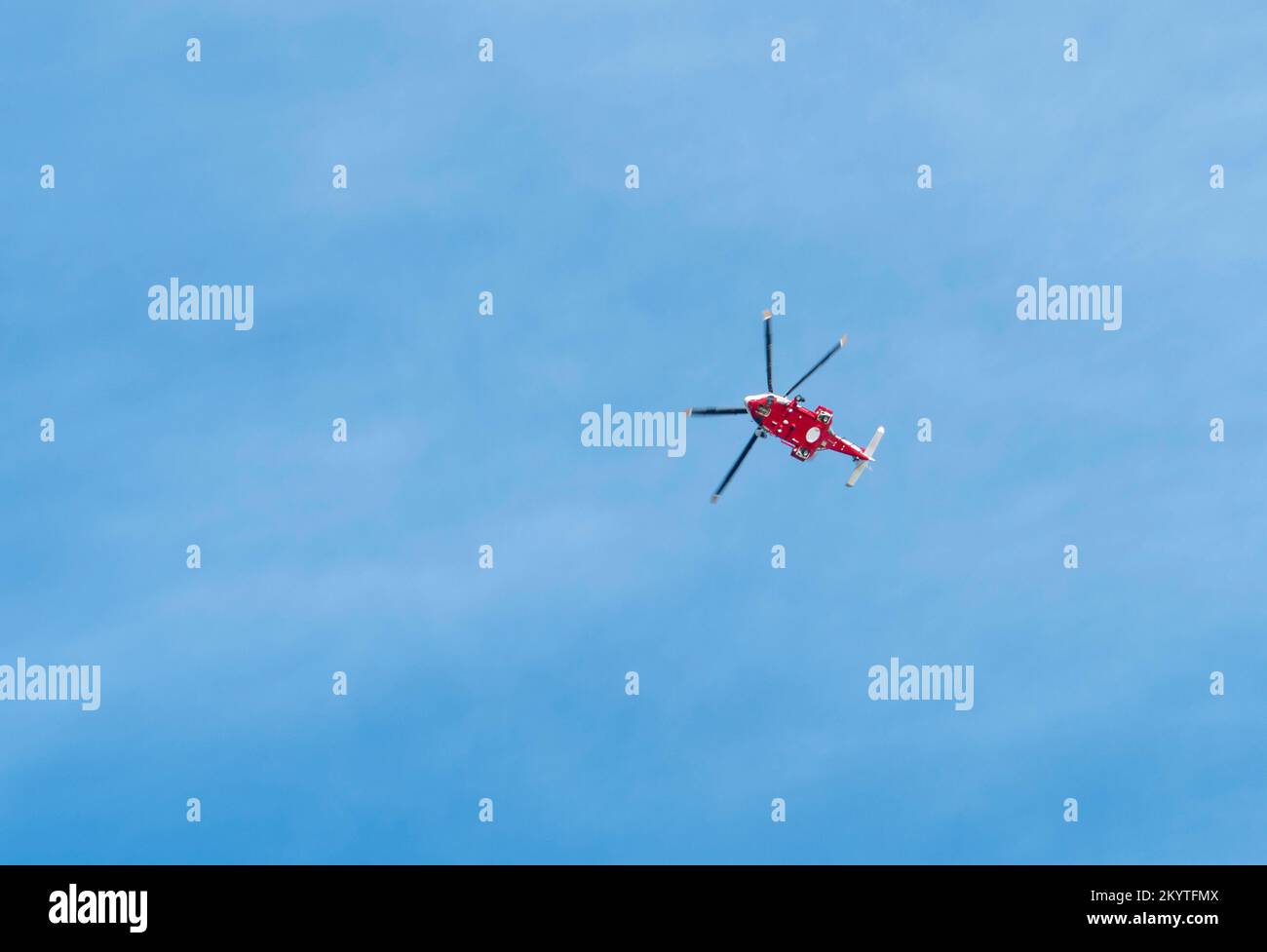 Low angle shot of a flying helicopter in front of blue sky Stock Photo ...