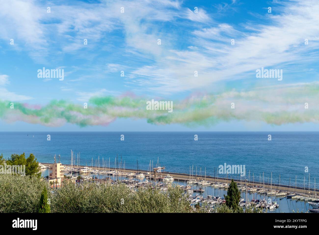 Coastal scenery with colorful fume trails of an air show seen in ...
