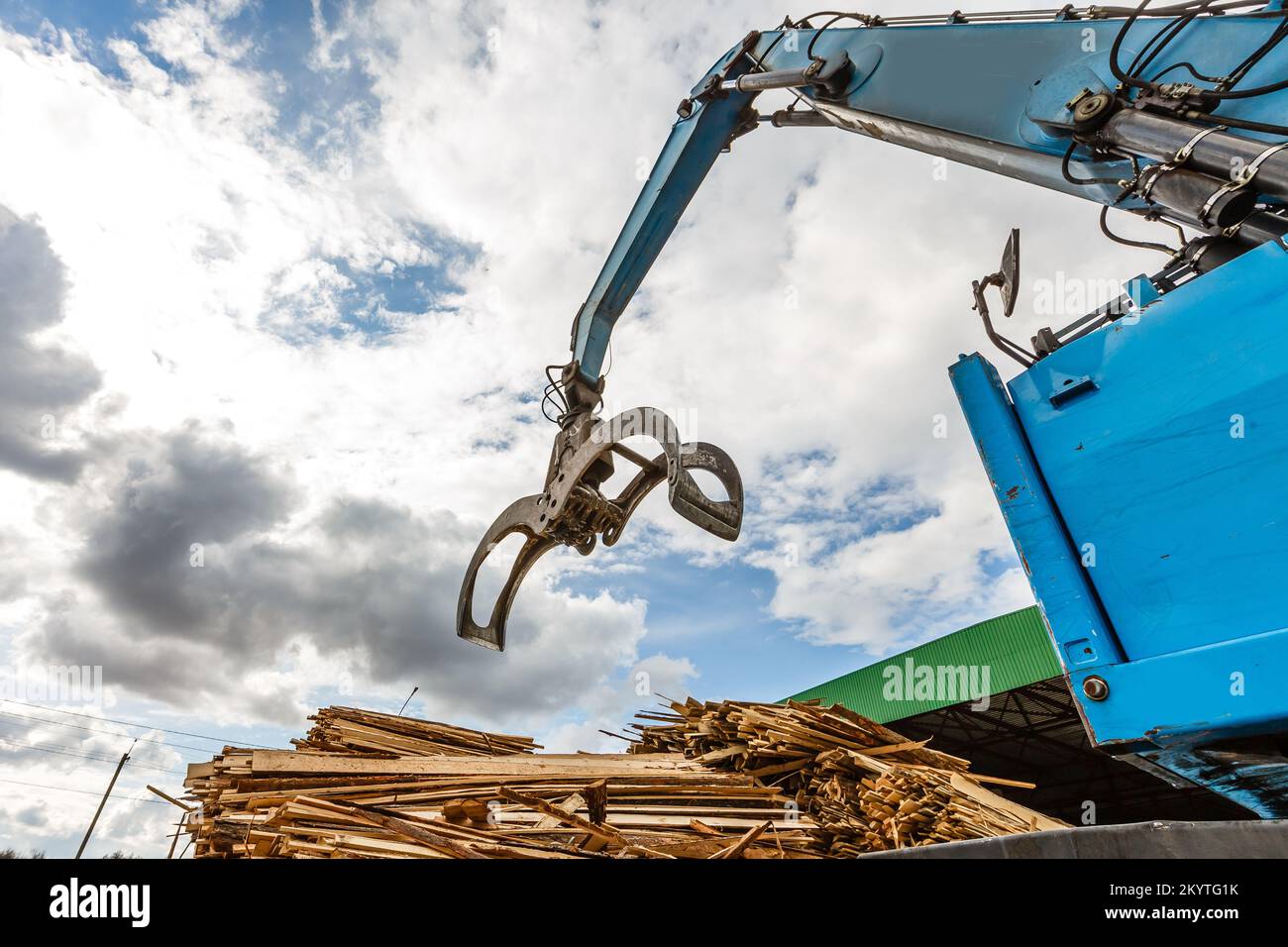 Log loader or forestry machine loads a log truck Stock Photo - Alamy