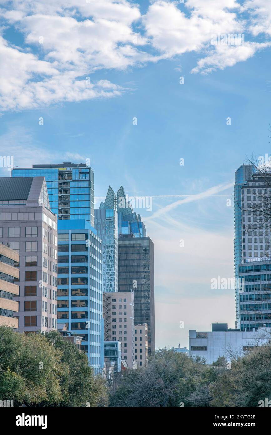 Austin, Texas- Cityscape with trees below the buildings with reflective ...