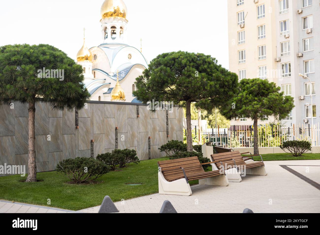 A modern bench in a city park on a sunny day. City improvement, urban ...